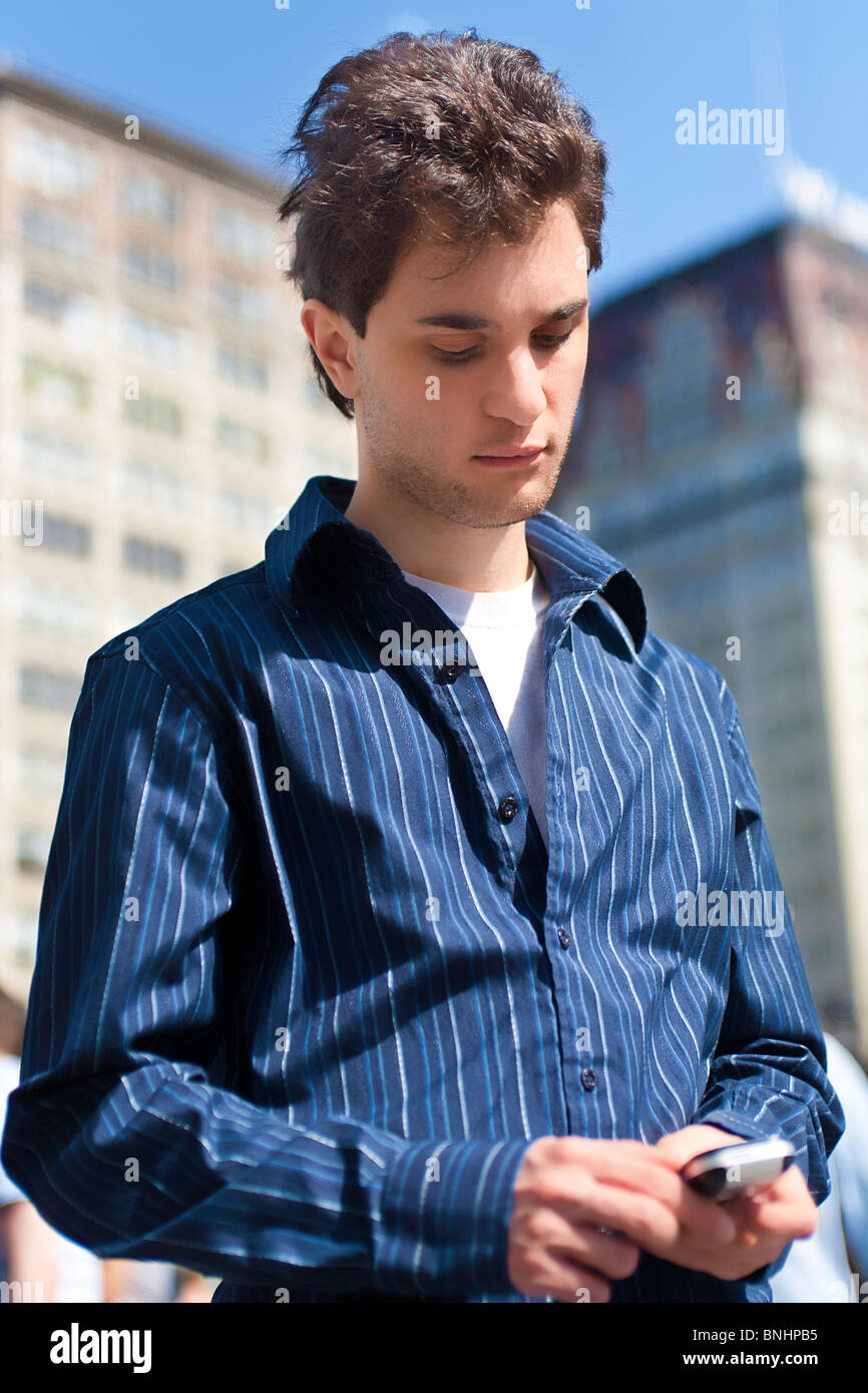 Young Man texting on a New York City Street Stock Photo - Alamy
