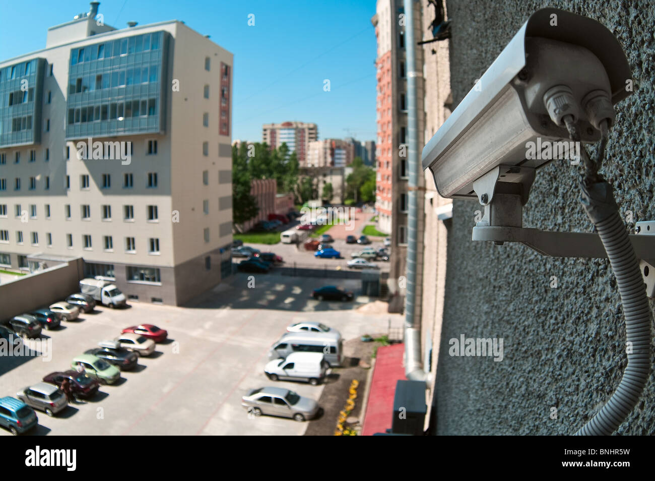 Optical camera on wall of building watching on parking place from top ...