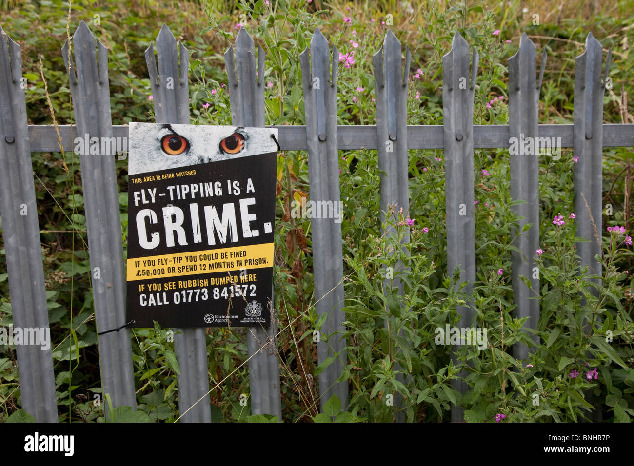 no fly tipping sign on railings Stock Photo - Alamy