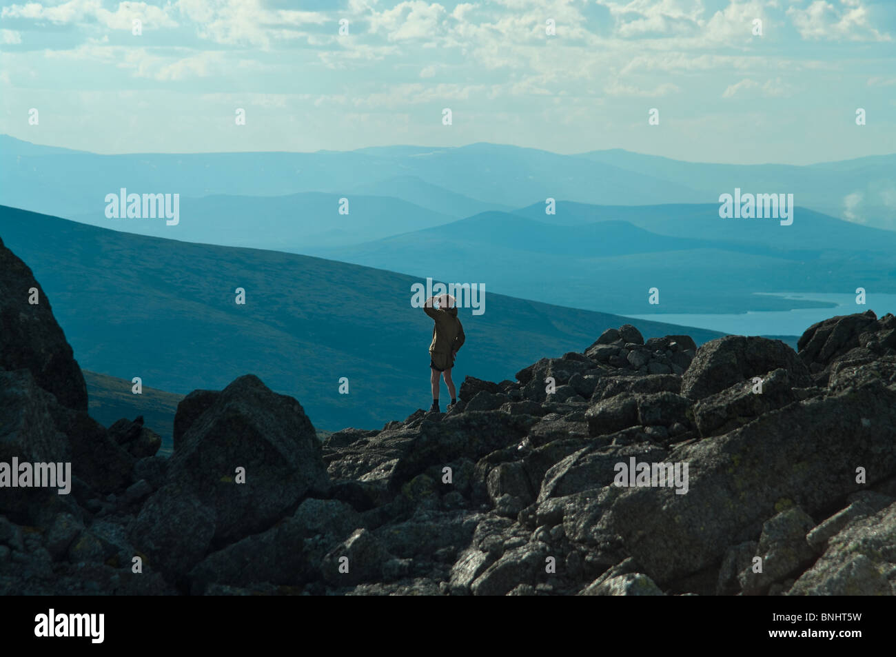 Man standing on top of mountain and looking forward. The Khibiny Massif ...