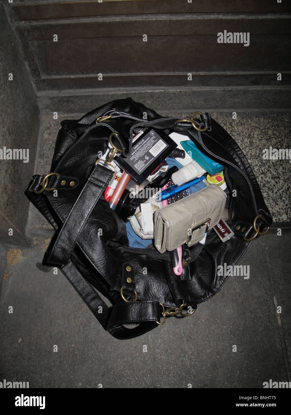 Open Handbag on doorstep outside at night Stock Photo - Alamy
