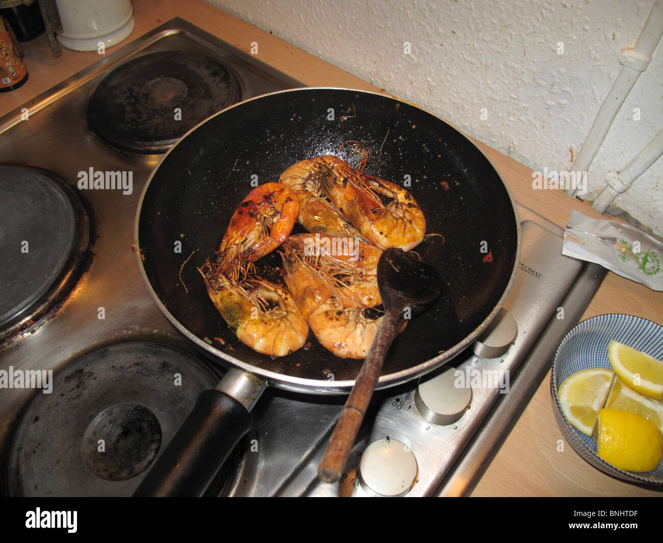King Prawns cooking in a pan on electric hob Stock Photo - Alamy
