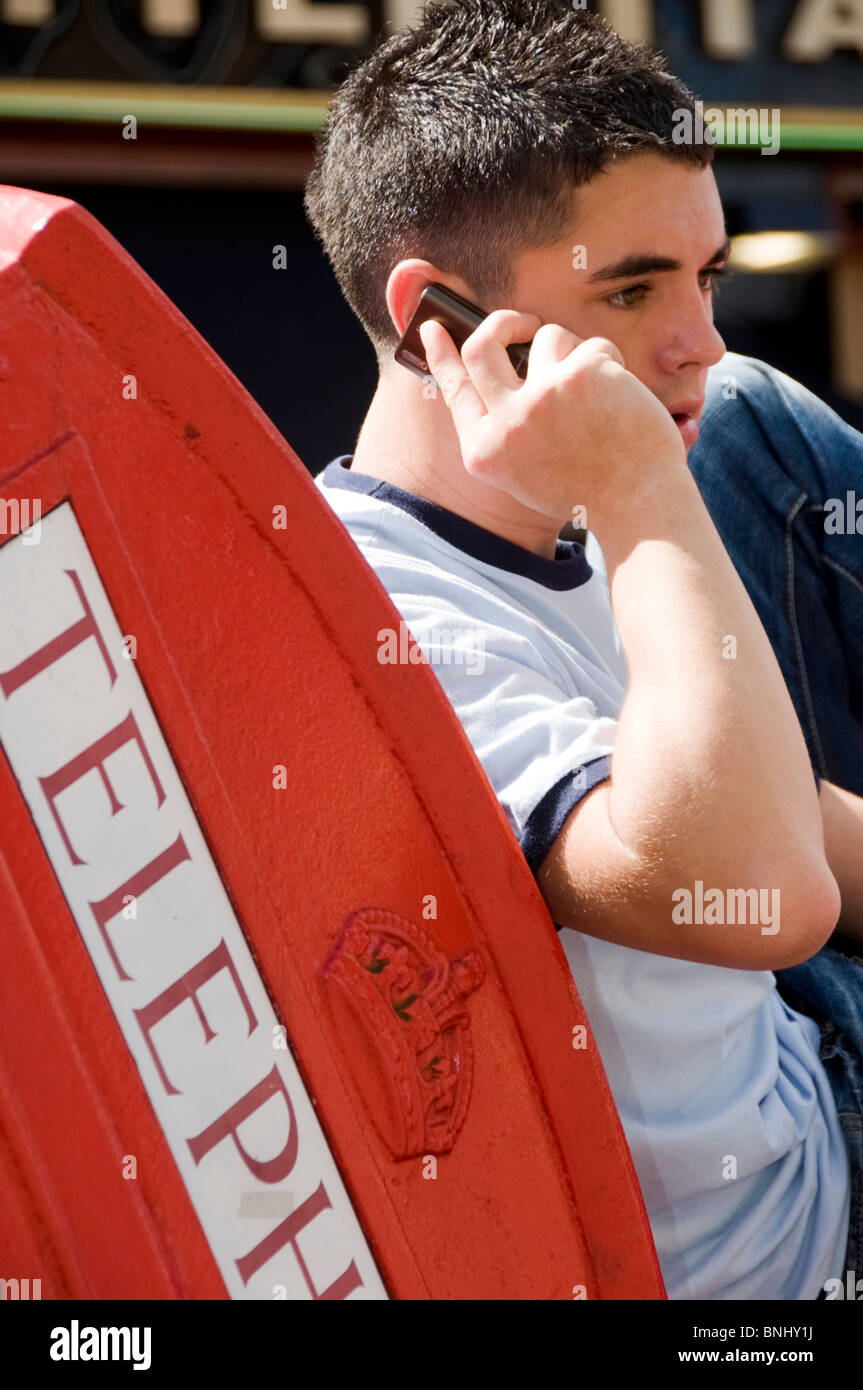 Youngster street town city urban young outside outdoors mobile phones ...