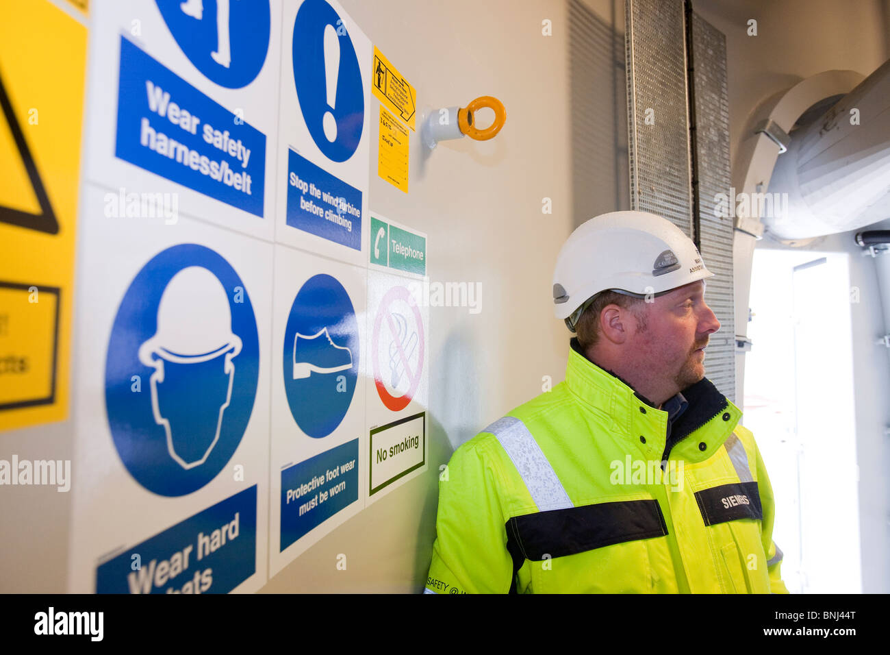 PPE instruction signs and an engineer inside a siemens offshore wind ...
