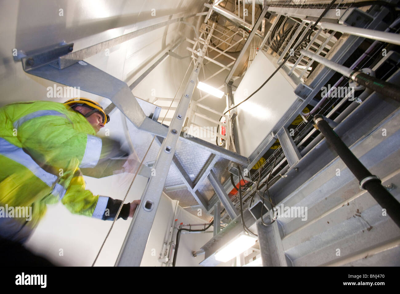 An engineer climbs the ladder of a Siemens wind turbine tower, destined ...