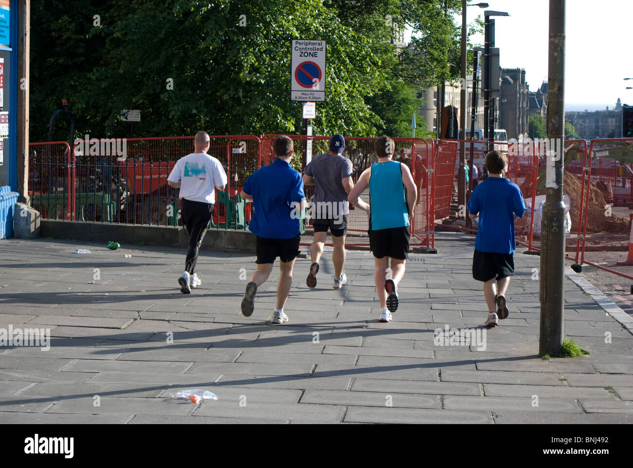 Five young men jogging down Leith Walk in Edinburgh, Scotland Stock ...