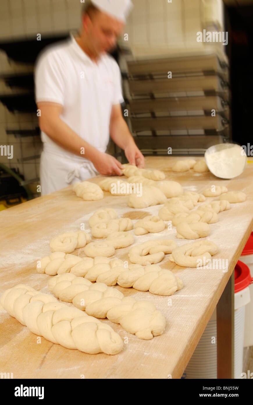 baker, blurred, forming cakes out of pastry Stock Photo - Alamy