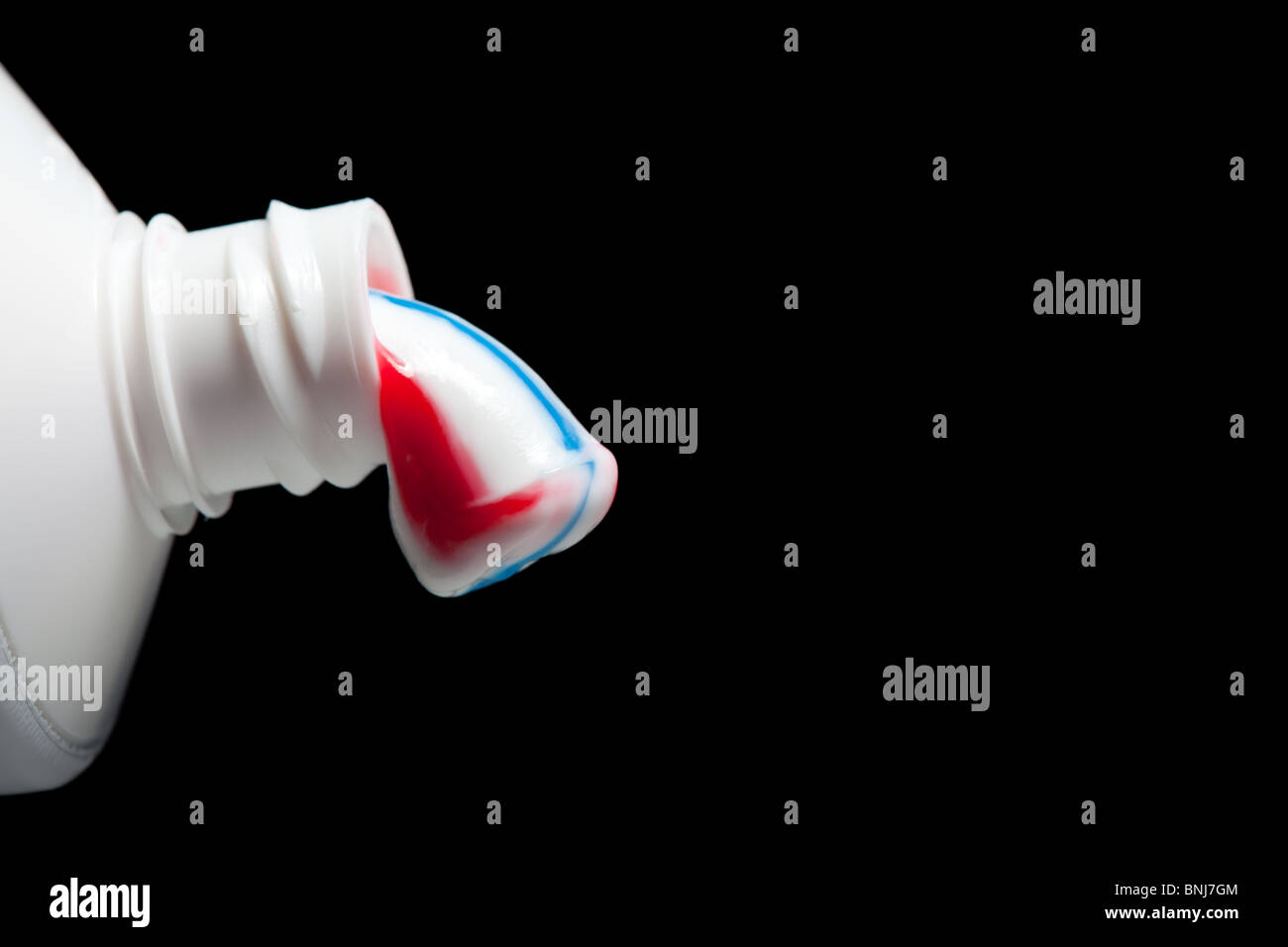 Stripy toothpaste being squeezed out of a tube Stock Photo - Alamy