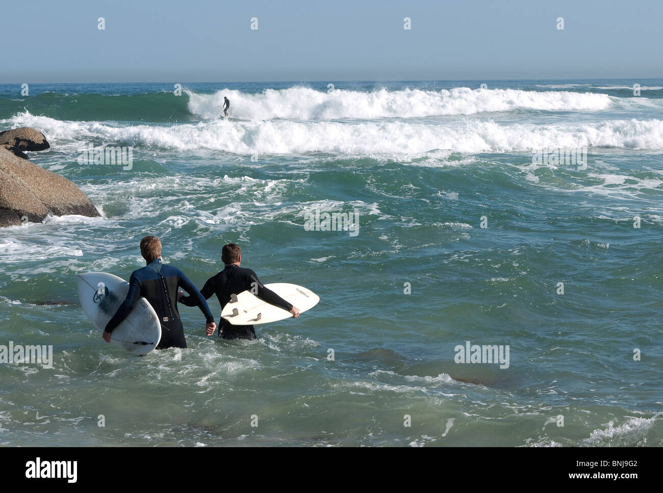 Surfers in the sea at Camps Bay Cape Town South Africa Stock Photo - Alamy