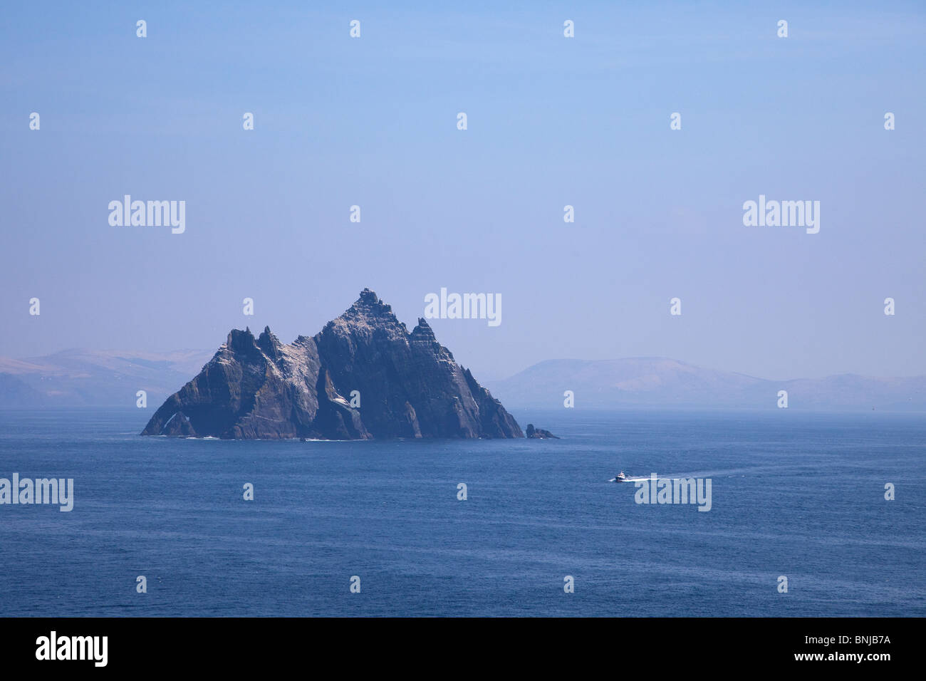 Fishing boat bringing tourists past Little Skellig County Co. Kerry in ...