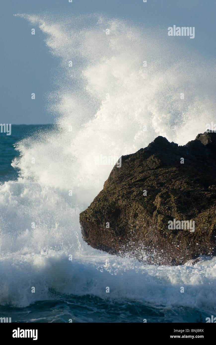 Waves crashing over rocks Stock Photo - Alamy