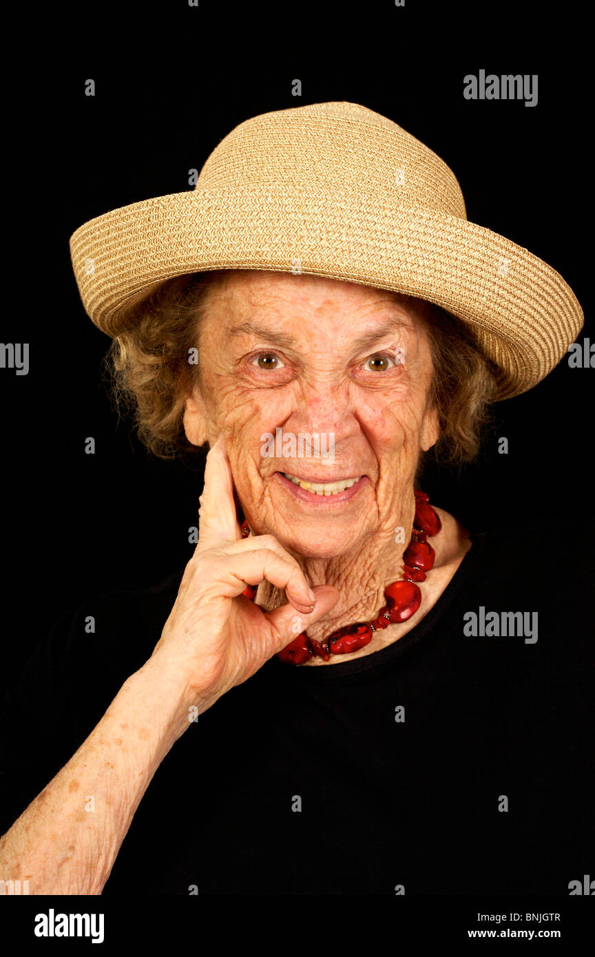 Up-close face of wrinkled elderly lady with hat on and big smile Stock ...