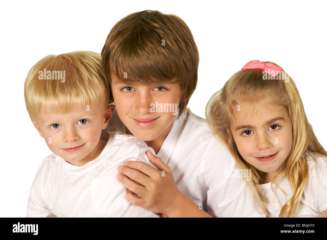 Portrait of a three beautiful brothers and sister all snuggled together ...