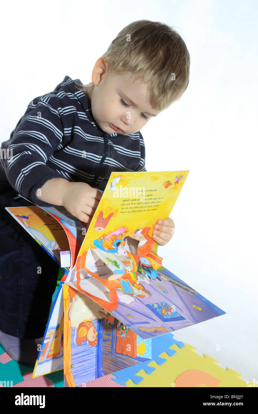 Cute baby boy with a book Stock Photo - Alamy