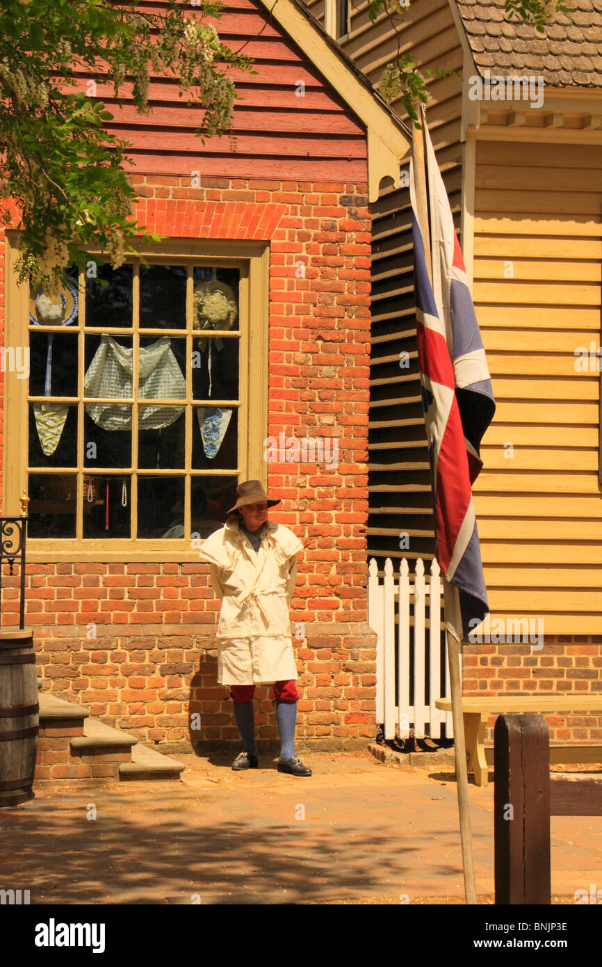 A costumed Interpreter stands outside his shop in the Historic Area ...