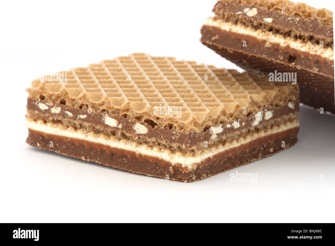 Two crunchy filled wafers with cacao cream and nuts Stock Photo - Alamy