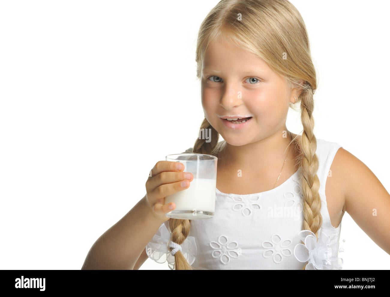 The pretty girl with a glass of milk. It is isolated on a white ...