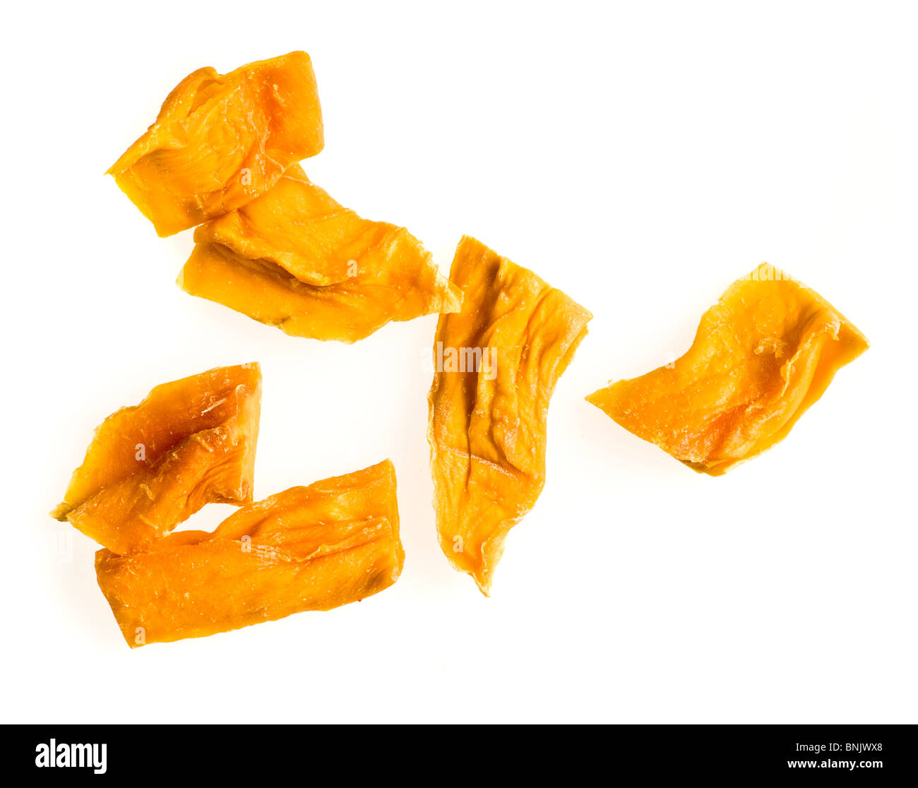 Dried mango pieces on white studio background Stock Photo - Alamy
