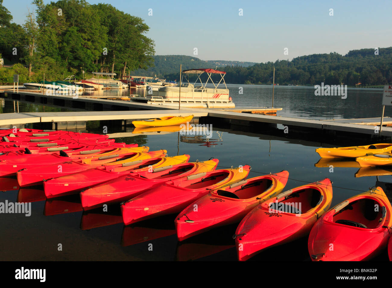Boats and colorful kayaks at a marina on Deep Creek Lake, Thayerville ...