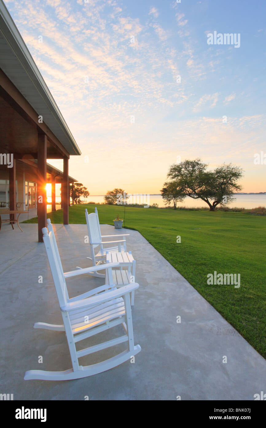 Rocking chairs on patio overlooking sunset over Bogue Sound, Country ...