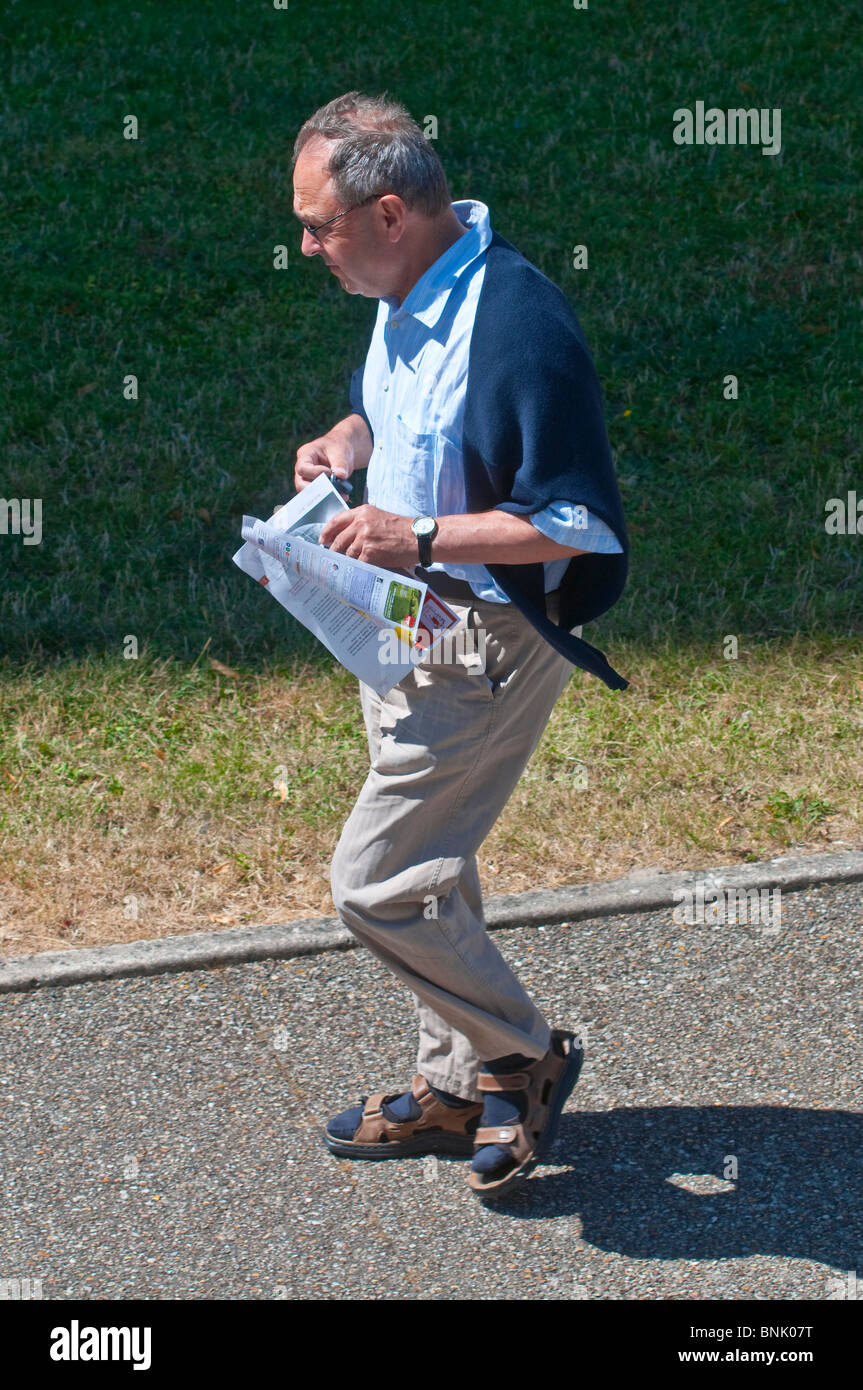 Mature / middle-aged man walking along pavement - France Stock Photo ...