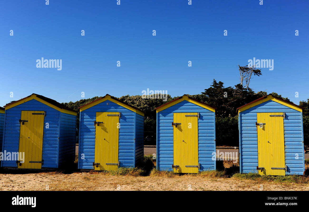 Blue and yellow beach huts along Littlehampton seafront West Sussex UK ...