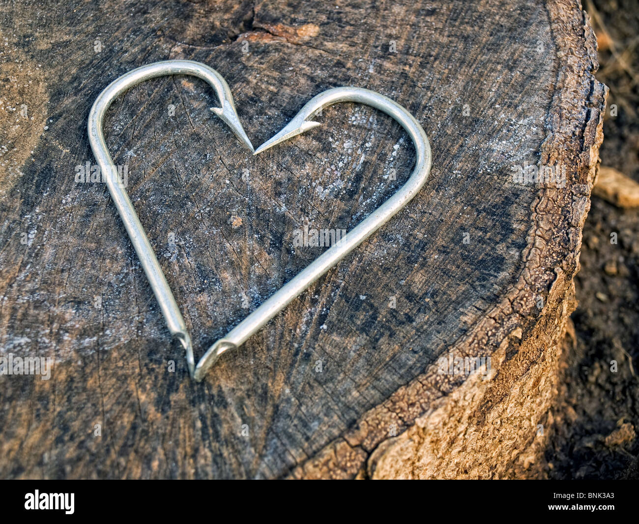 Hooks in a shape like a heart, on the wooden background Stock Photo - Alamy
