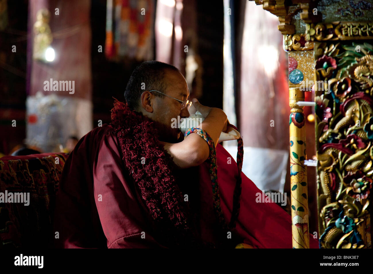 Monk blowing the sacred white conch in Sakya Monastery in Sakya, Tibet ...