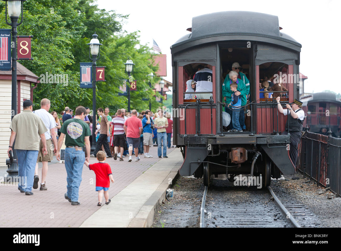 A Steam Locomotive Train pulling into the train station with passengers ...