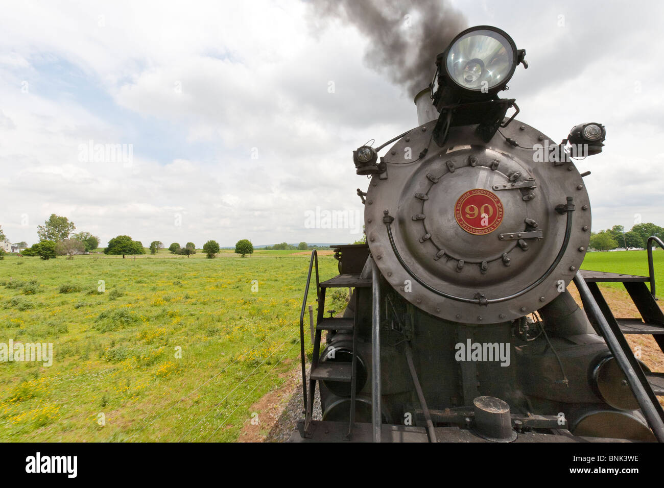 A Steam Locomotive Train traveling across the horizon Stock Photo - Alamy
