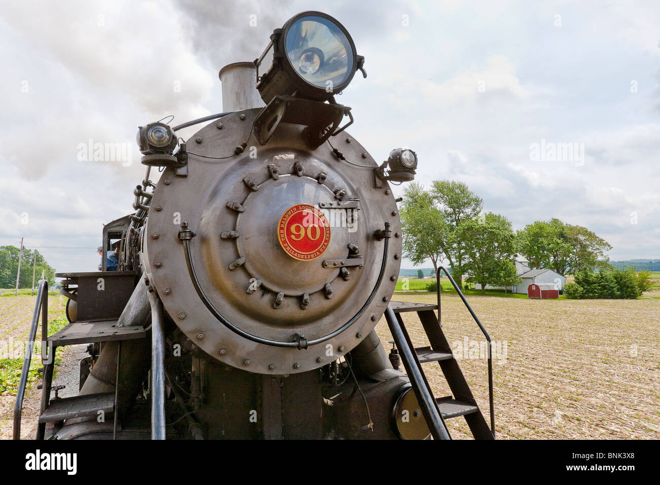 A Steam Locomotive Train traveling across the horizon Stock Photo - Alamy