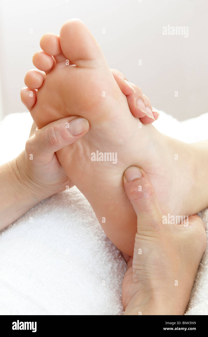 sole of a foot being massaged by pair of hands Stock Photo - Alamy