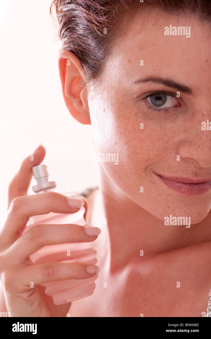 woman spraying perfume Stock Photo - Alamy