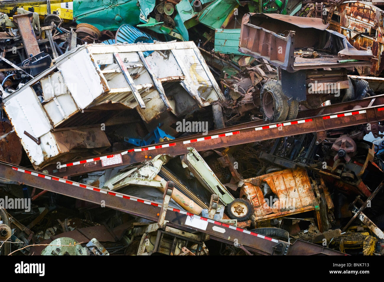 Large scale industrial scrap metal is piled one hundred feet high ...