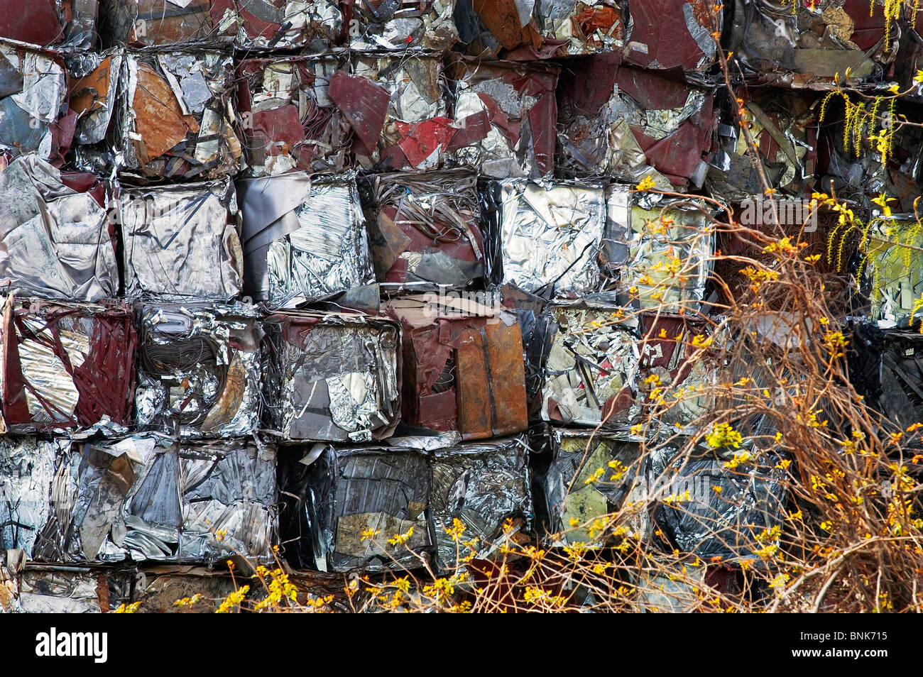 Scrap aluminum is baled and stacked high, ready for transport and ...