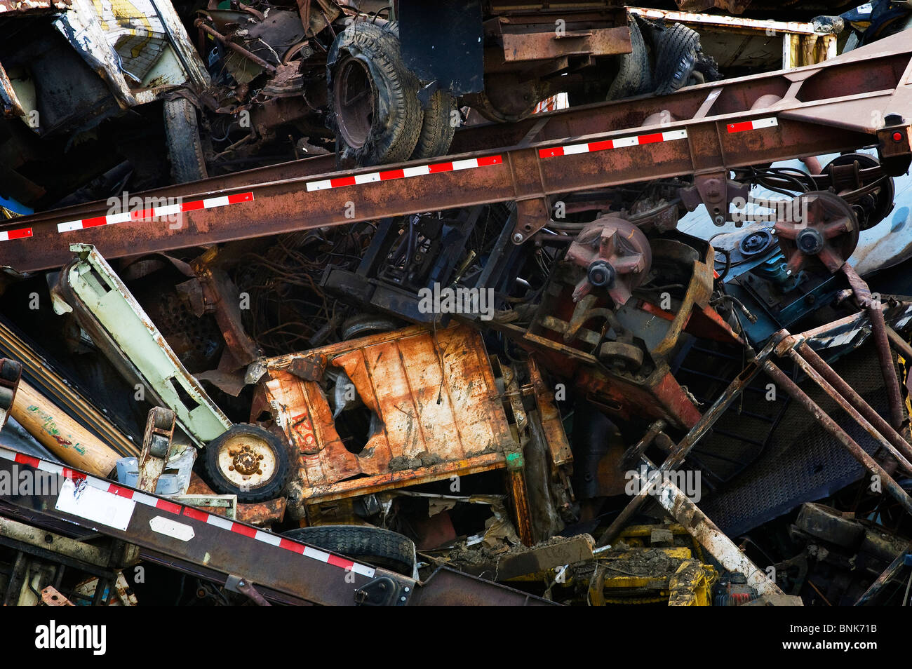Large scale industrial scrap metal is piled one hundred feet high ...
