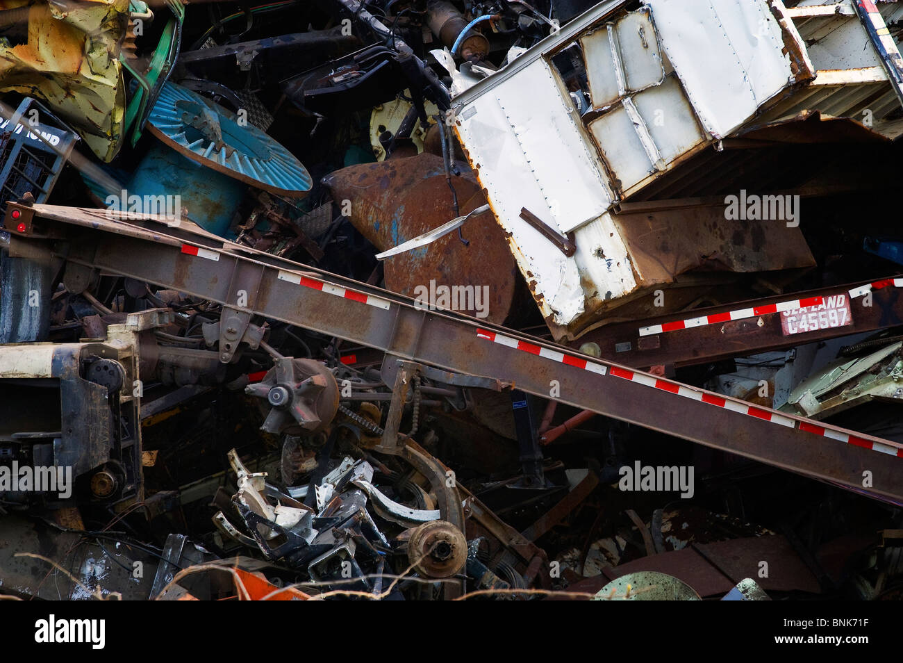 Large scale industrial scrap metal is piled one hundred feet high ...