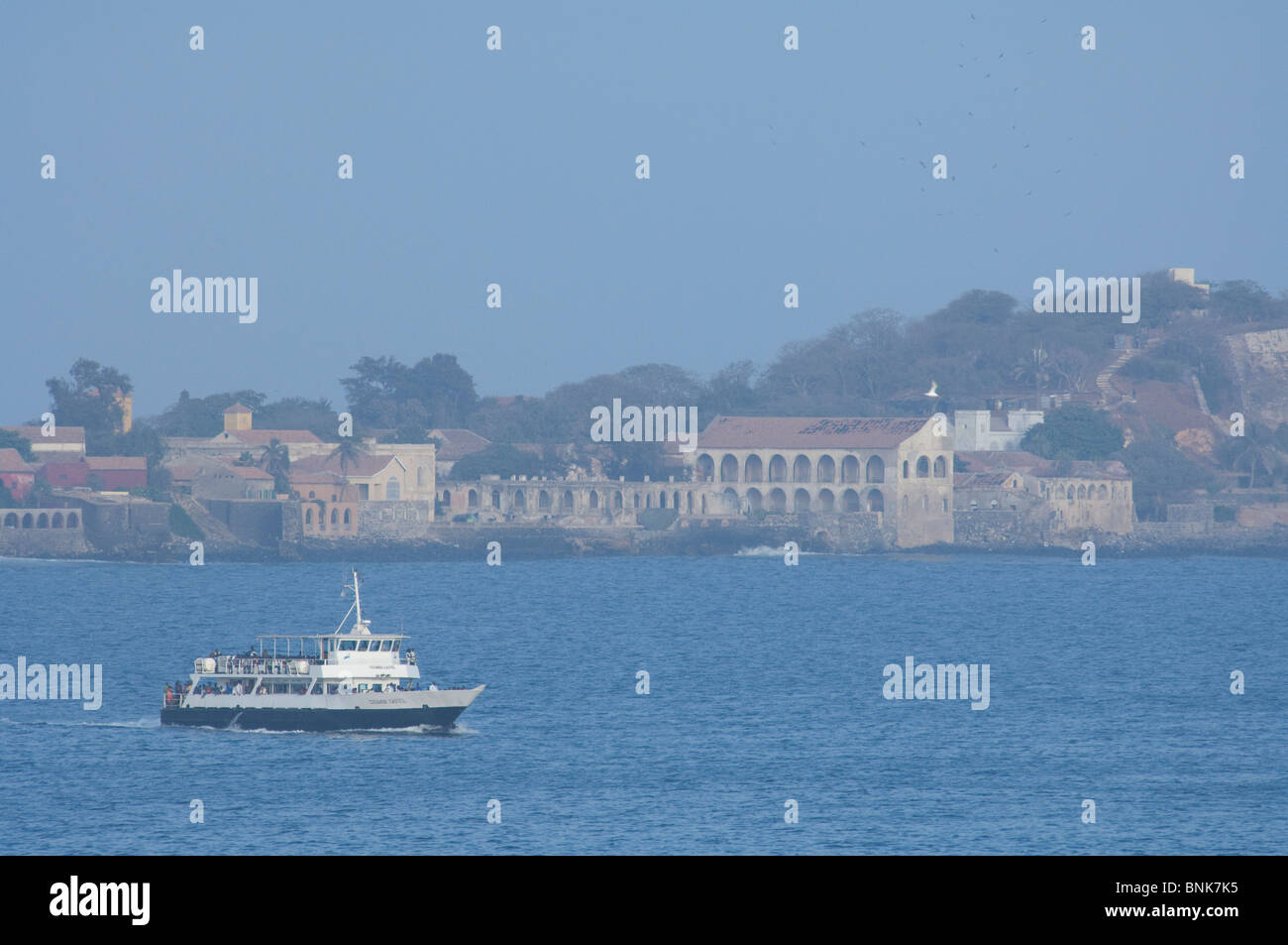 Africa, Senegal, Dakar. Local ferry in front of historic Ile De Goree ...