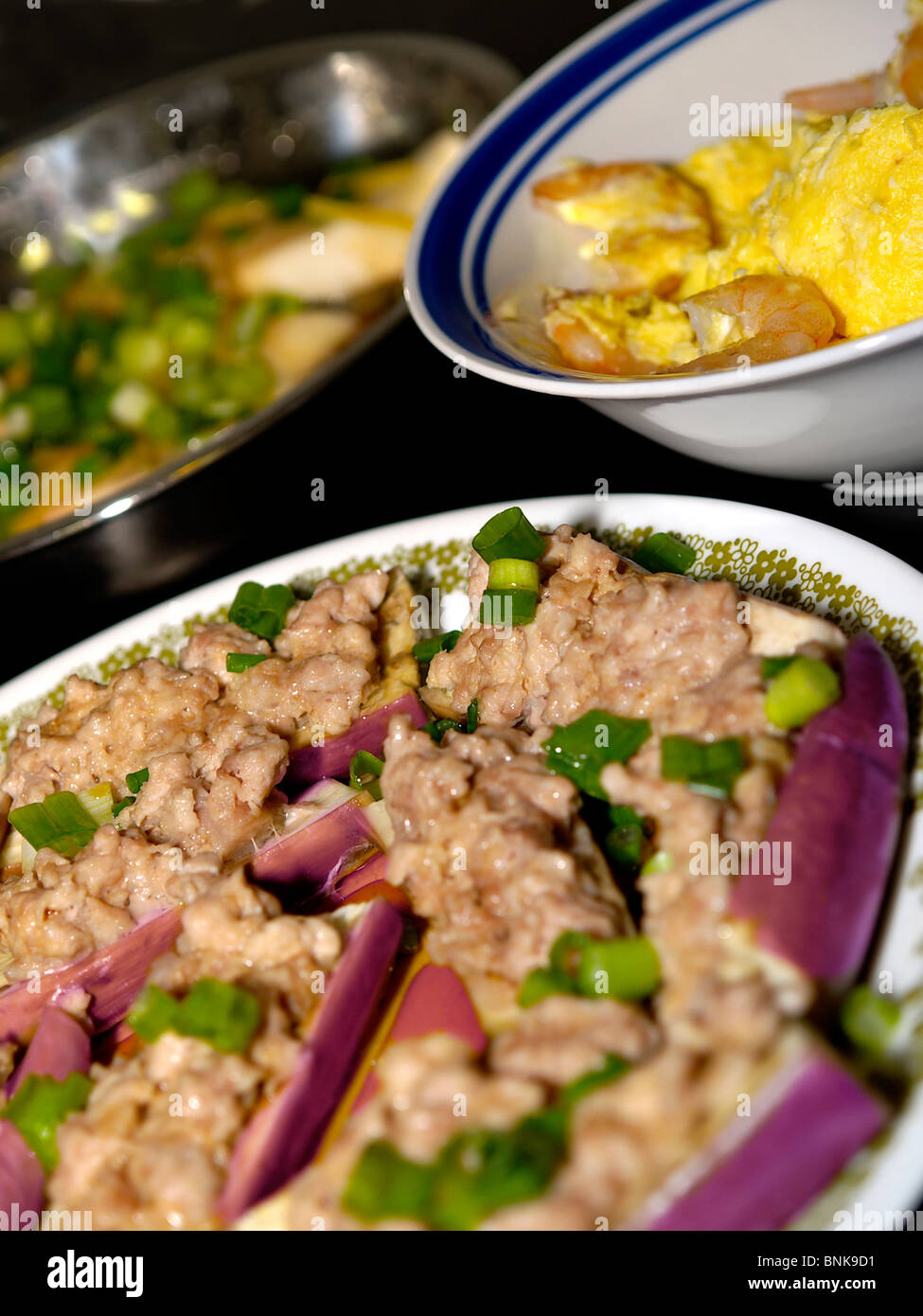 Three dish Chinese dinner on a black table Stock Photo - Alamy