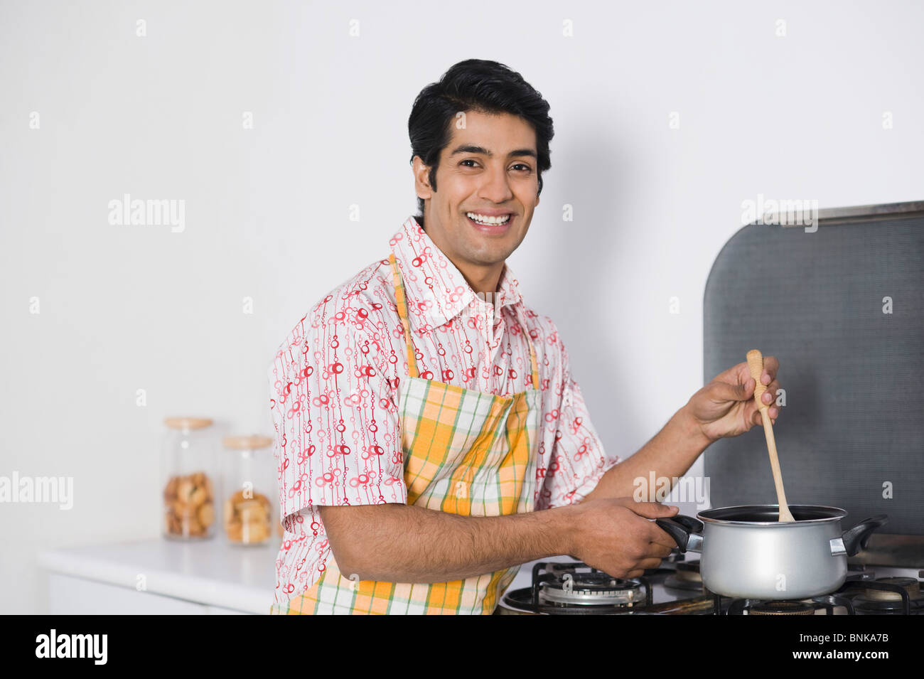 Man cooking food in the kitchen Stock Photo - Alamy