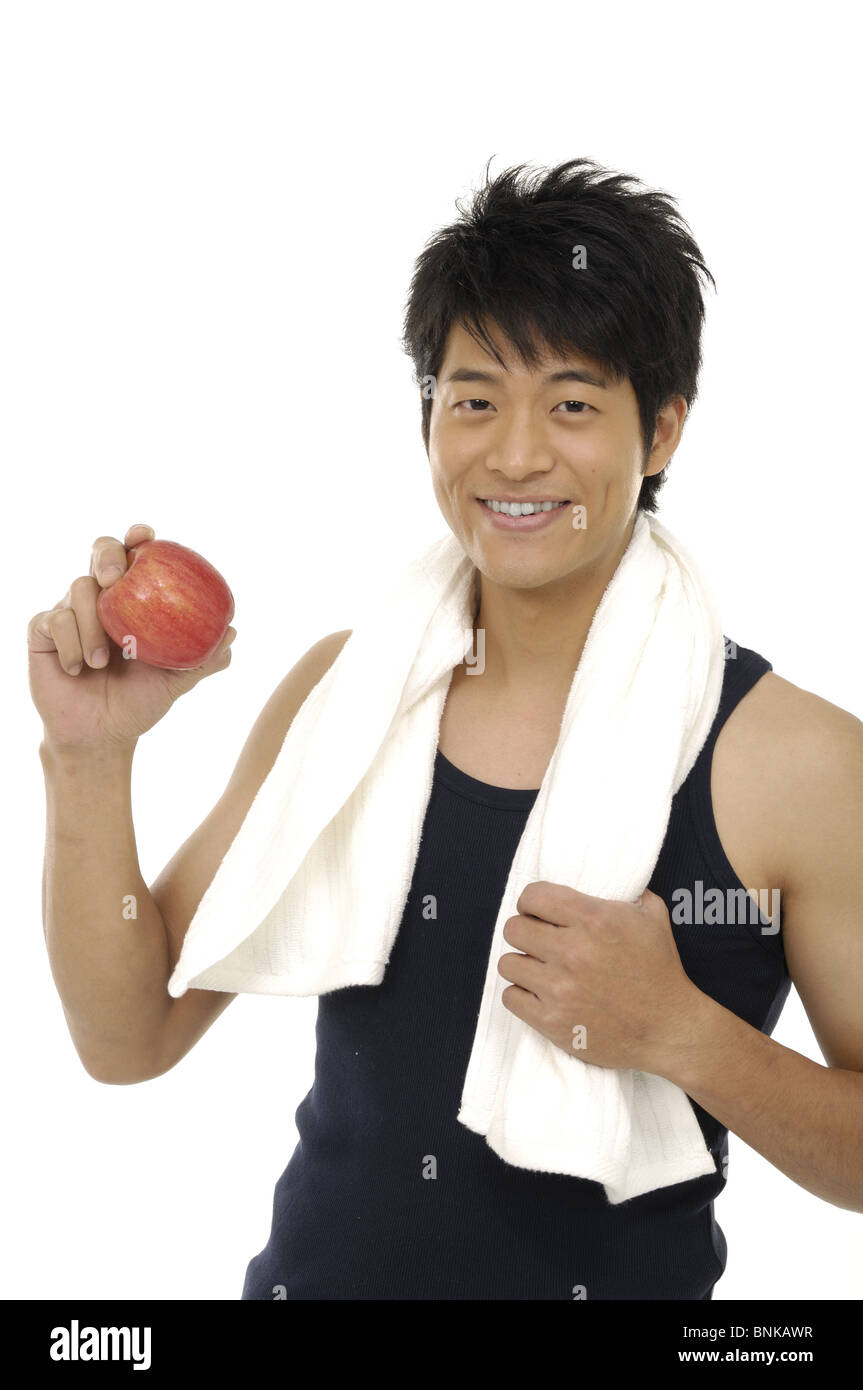 Portrait of a young man eating an apple Stock Photo - Alamy