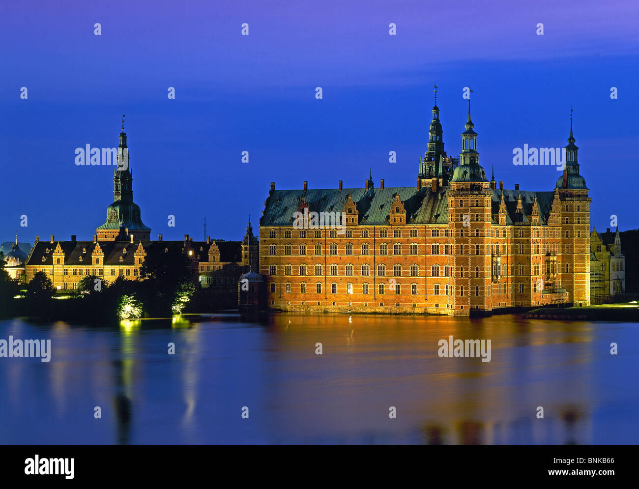 Denmark Hillerod castle Frederiksborg at night water jump lighting ...
