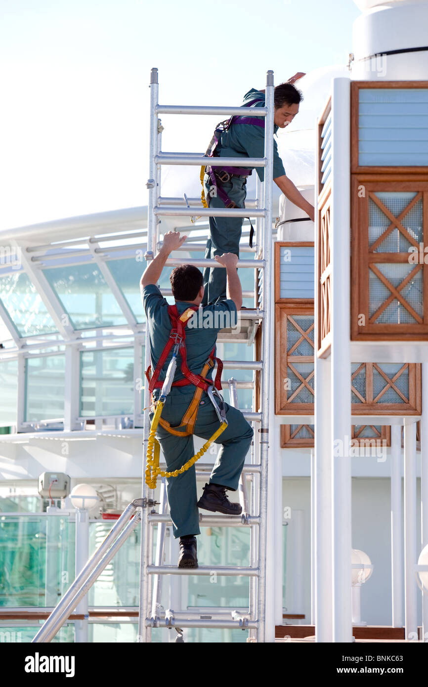 maintenance on board passenger liner. Ship's crew man kitted with all ...