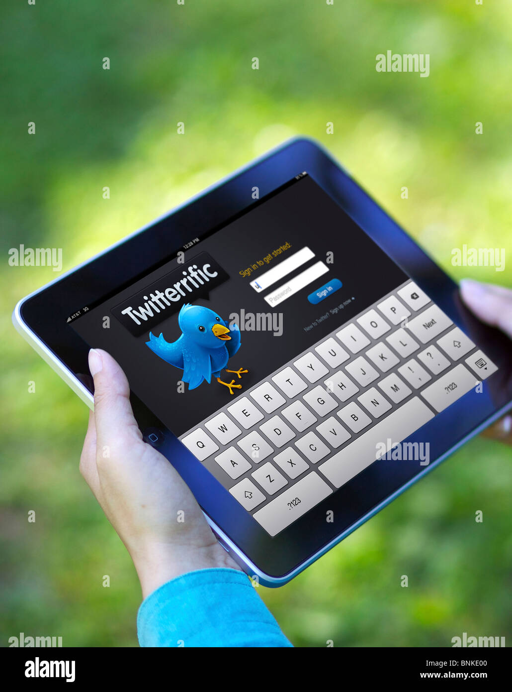 A woman hand holding an iPad showing close up of a Twitter iPad ...