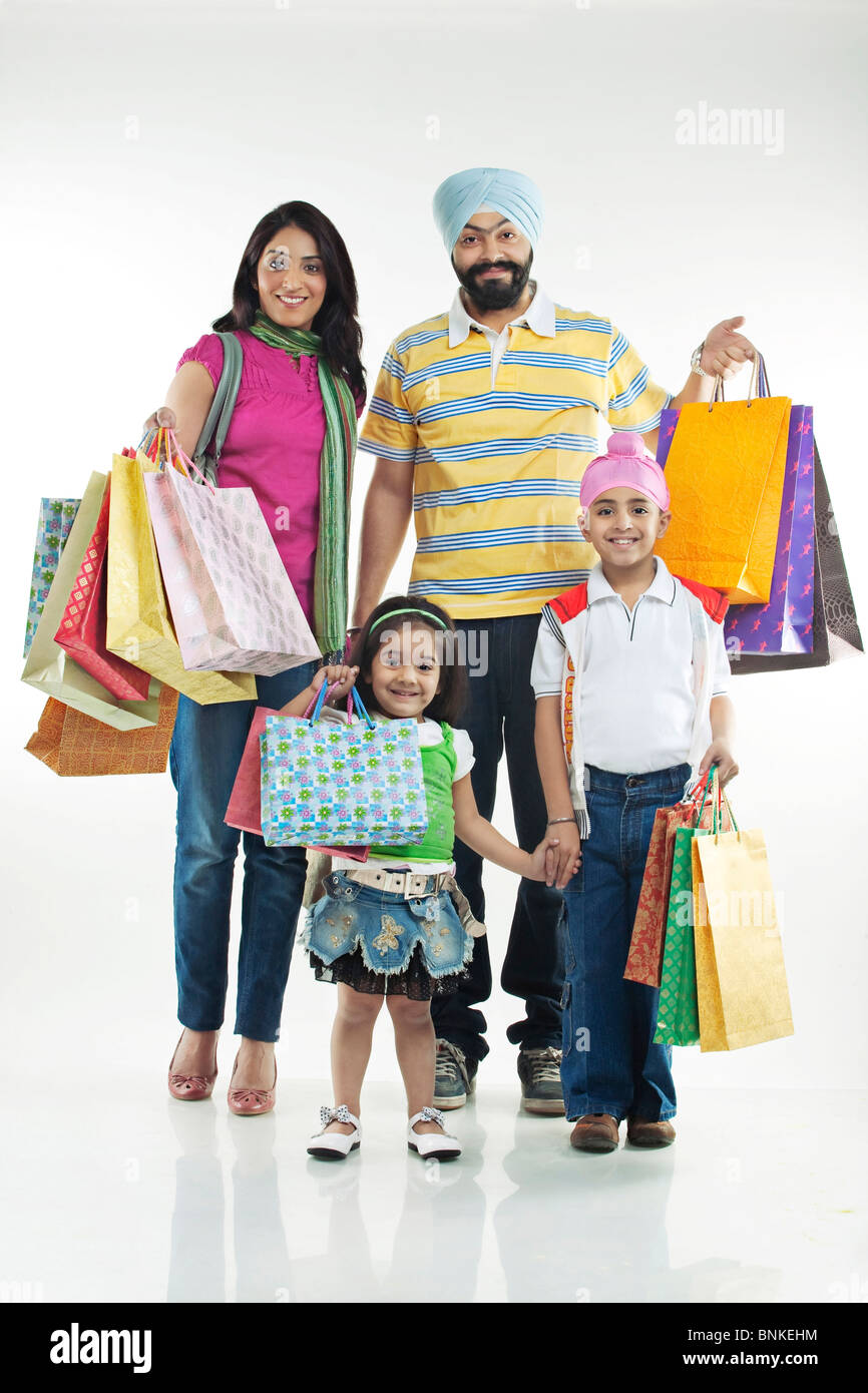 Family with shopping bags Stock Photo - Alamy