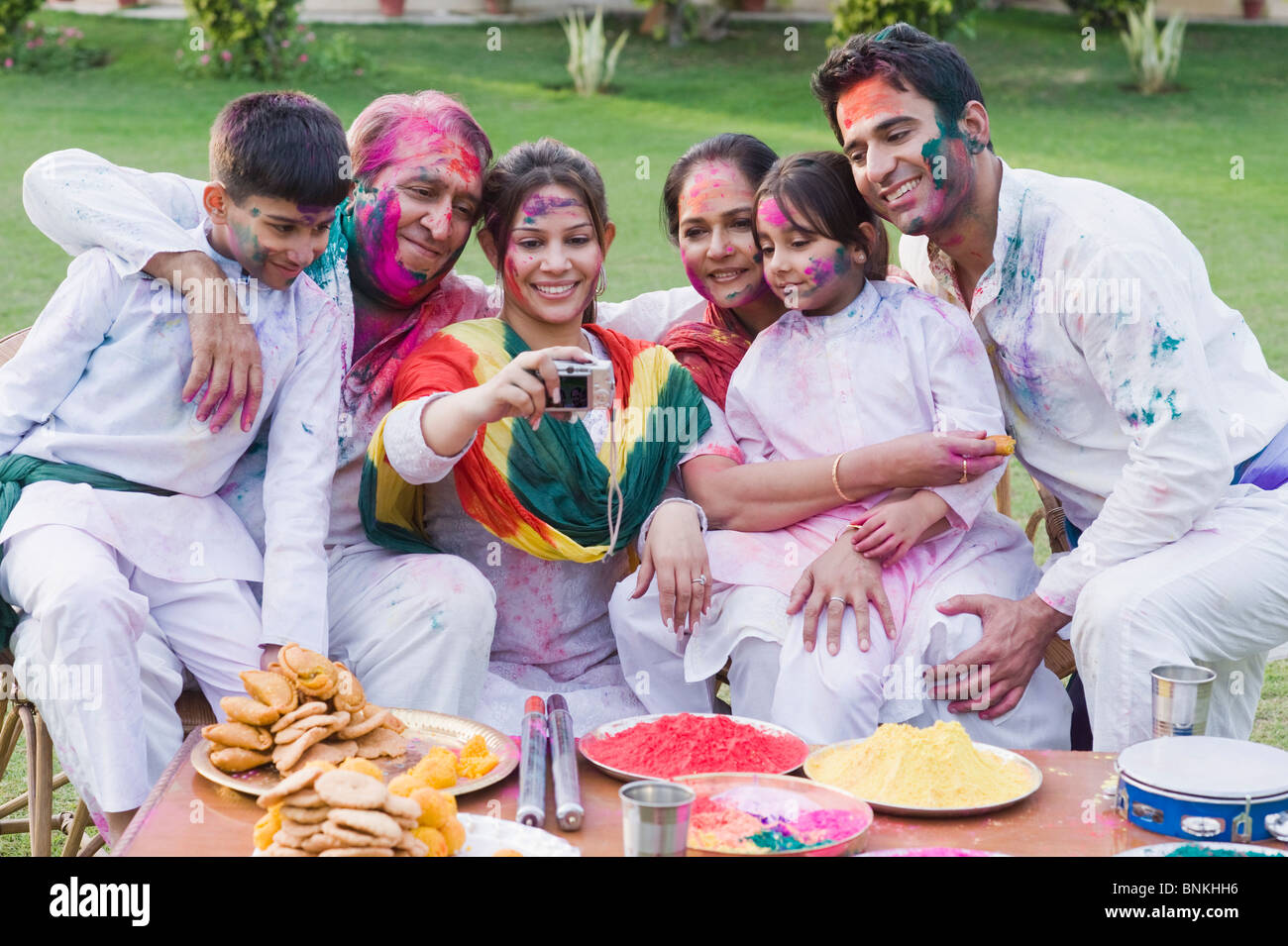 Family taking a picture of themselves with a camera on Holi Stock Photo ...