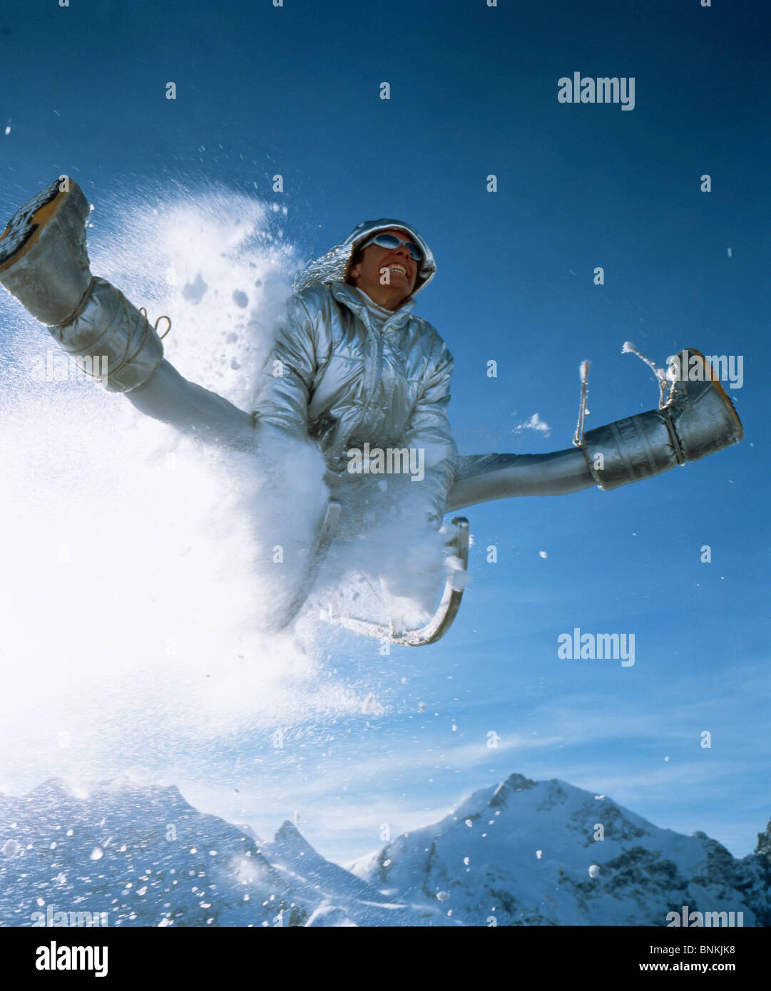 Switzerland winter sports sledge sleigh jump sledge jump woman person ...