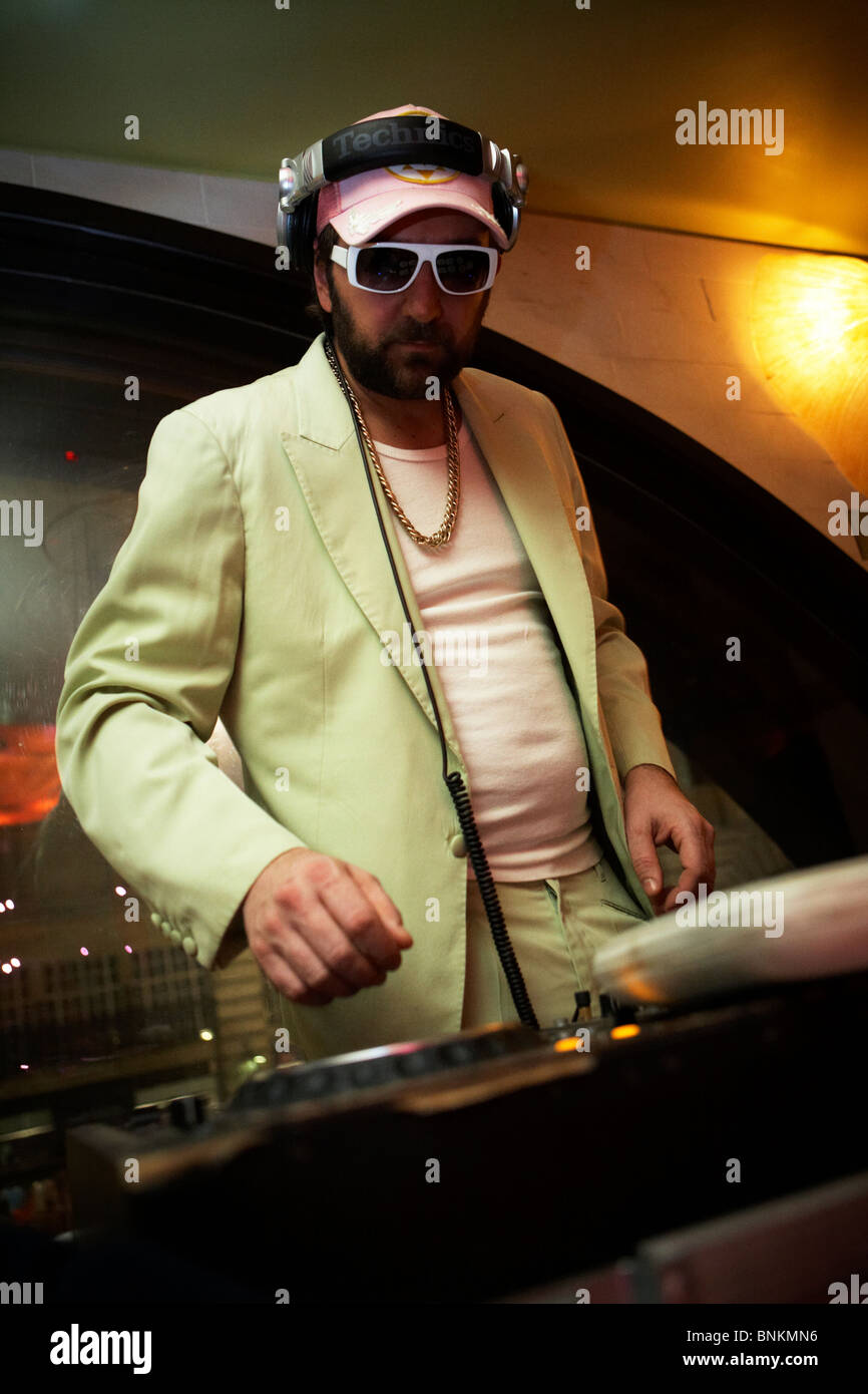A London party DJ dressed in white with a retro look Stock Photo - Alamy