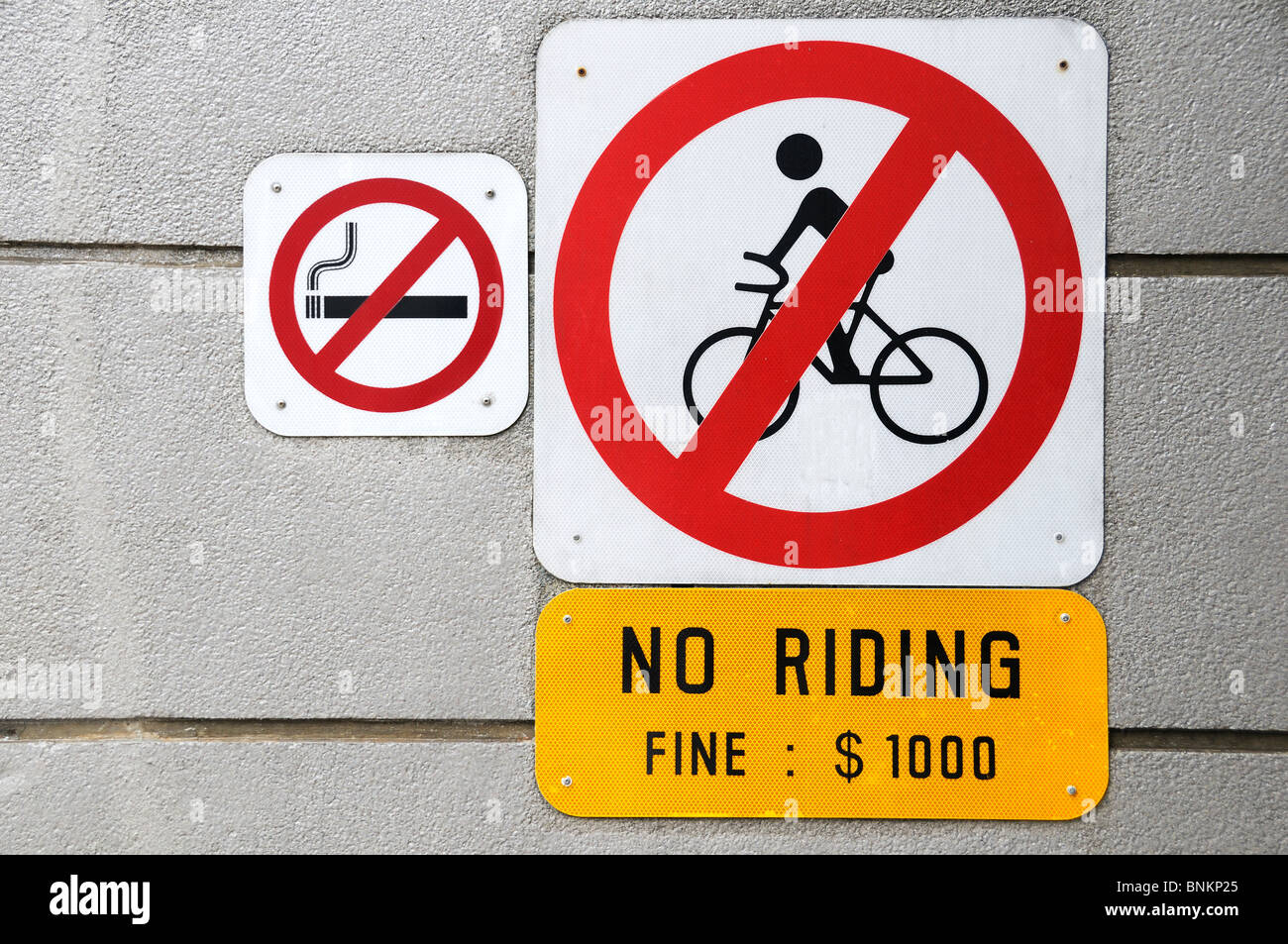 prohibition sign for no smoking and no riding a bike under a bridge in ...