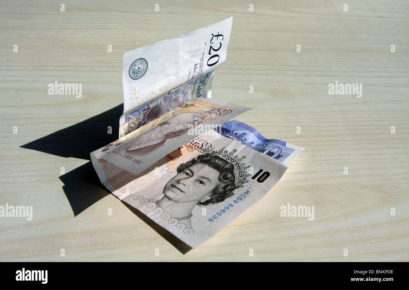 a part-folded sterling £20 note and £10 note Stock Photo - Alamy
